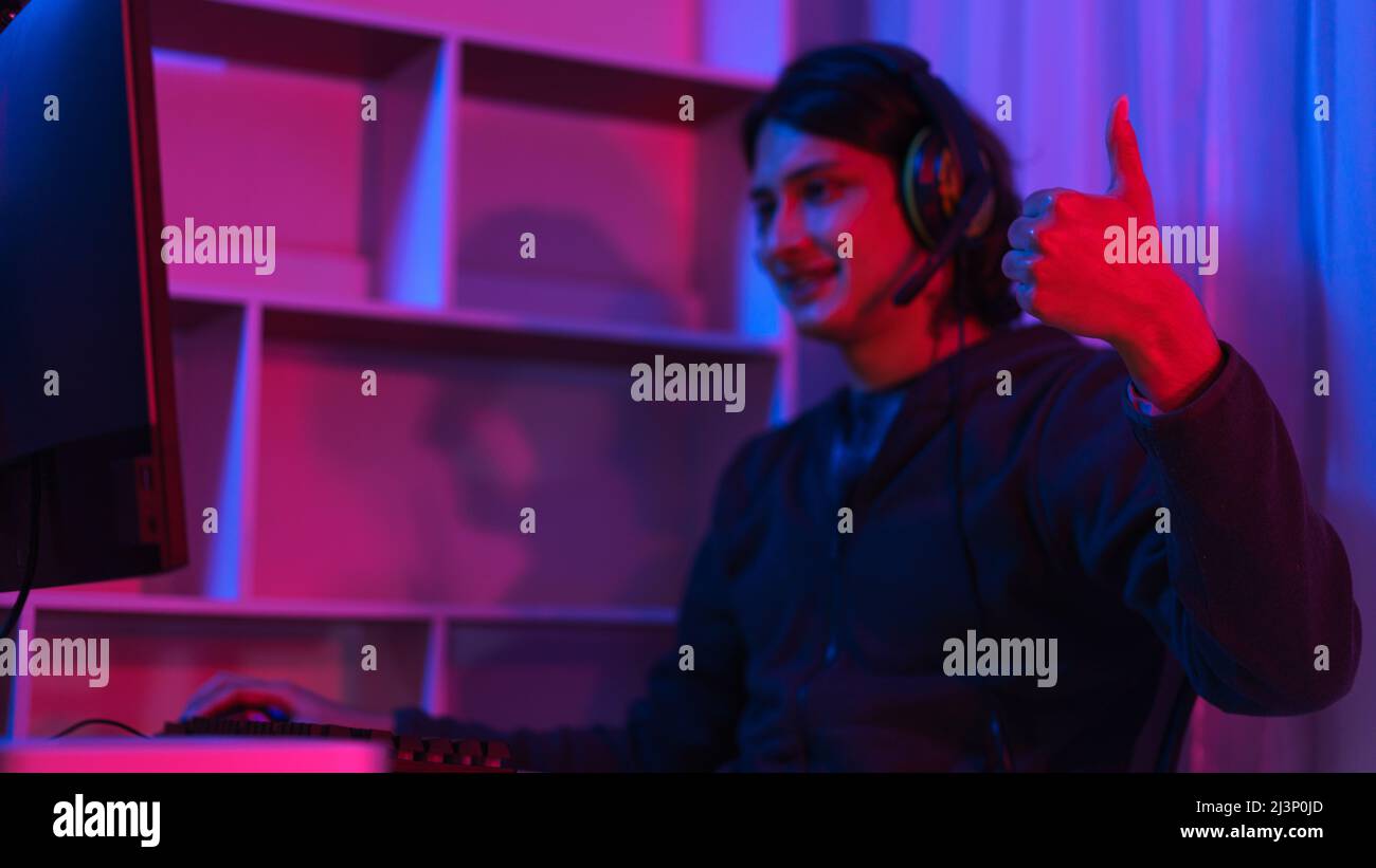 Game stream concept, Male streamer wear headset and have fun to play ...