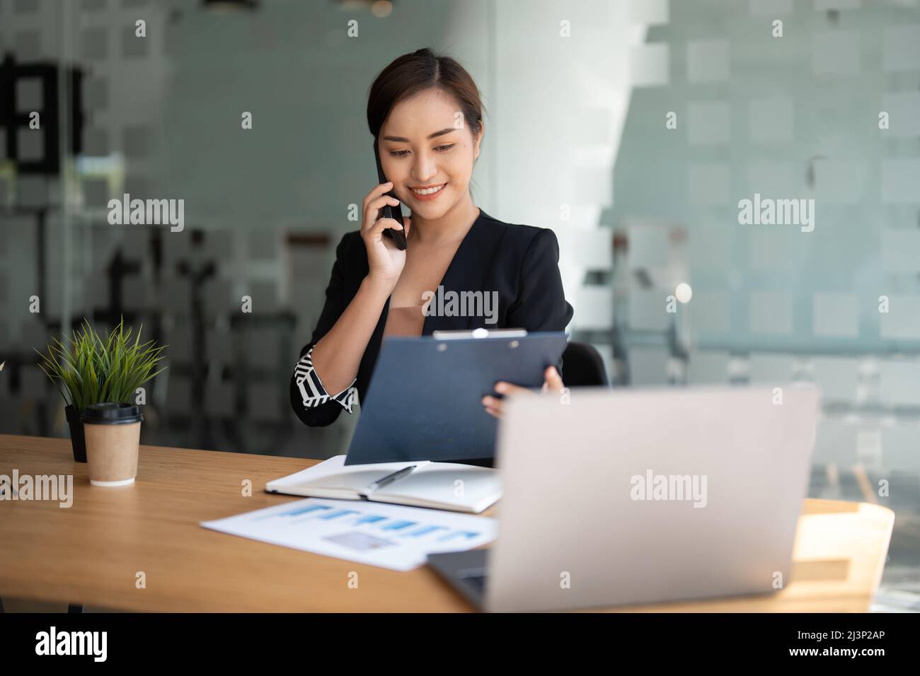 Young accountant marketing call consultants and using laptop computer ...