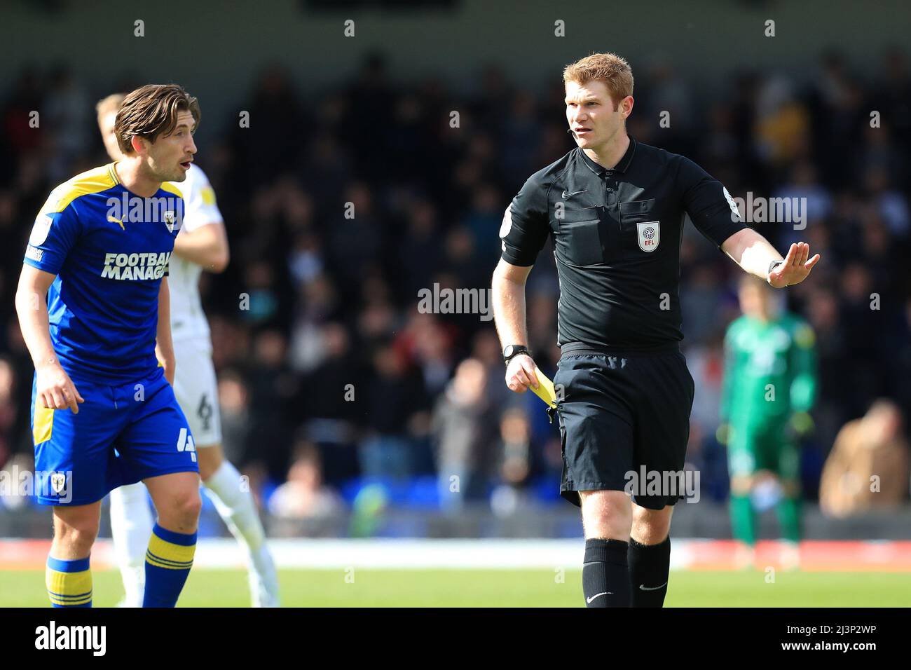 Referee, James Oldham brandishing a yellow card Stock Photo - Alamy