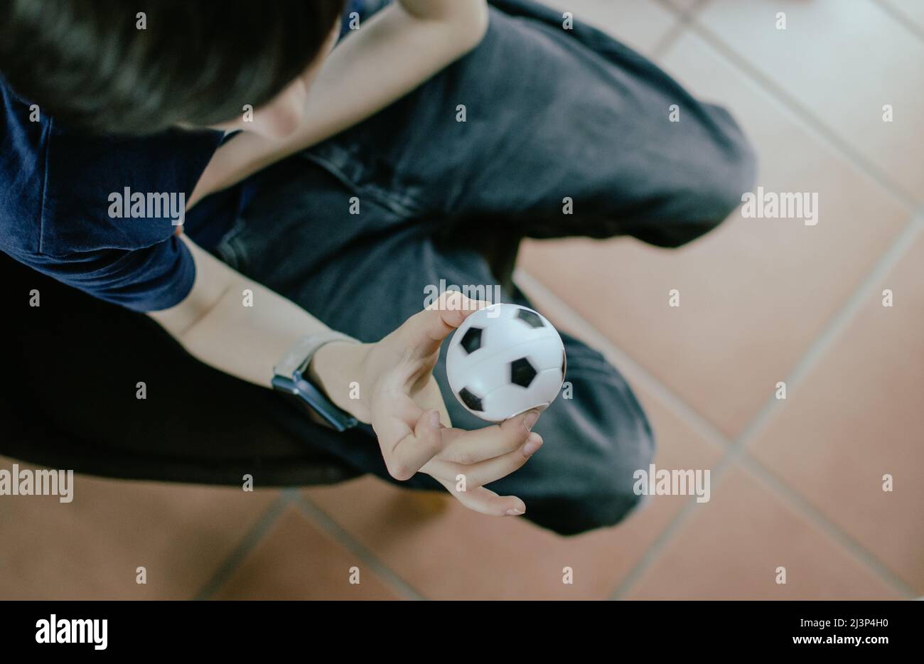 Boy using a stress ball Stock Photo - Alamy
