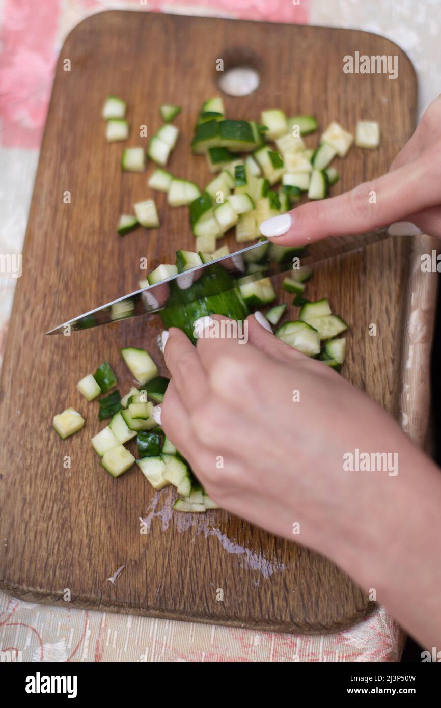 Woman cuts cucumber on hi-res stock photography and images - Alamy