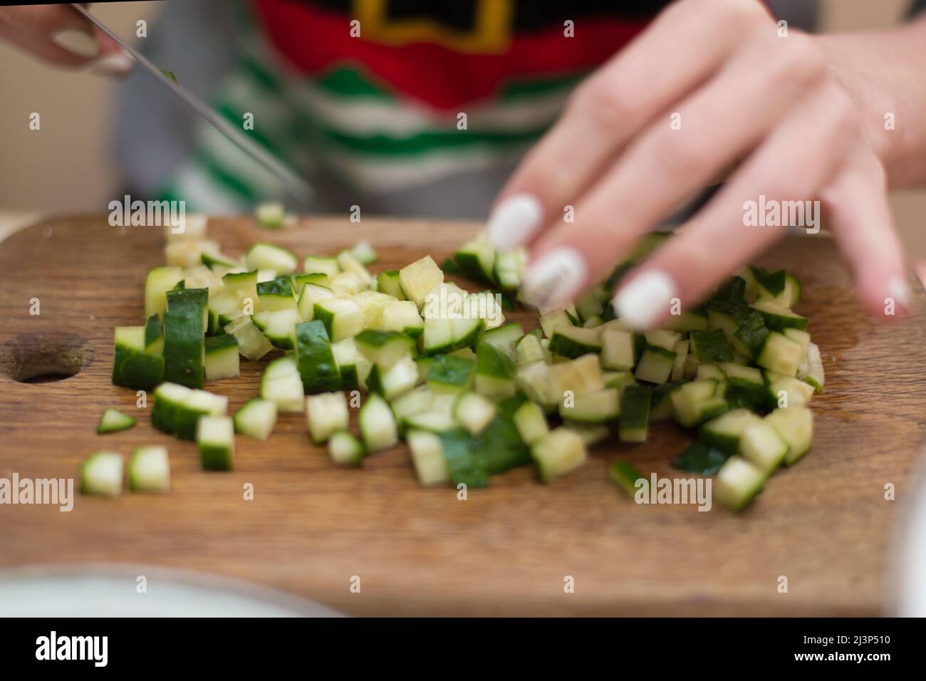 Woman cuts cucumber on cutting hi-res stock photography and images - Alamy