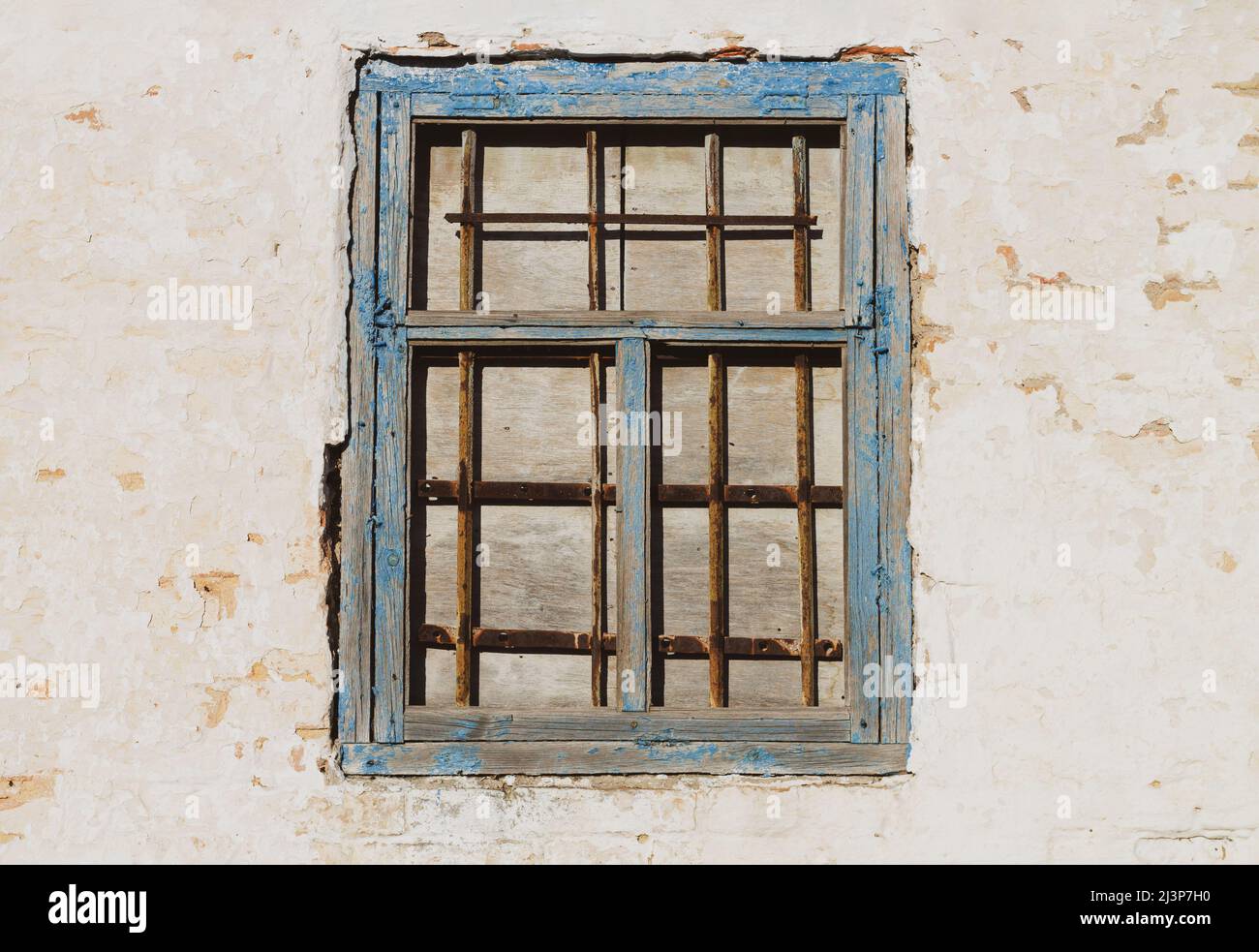 Old building wall and closed wooden window with rust iron grille Stock ...