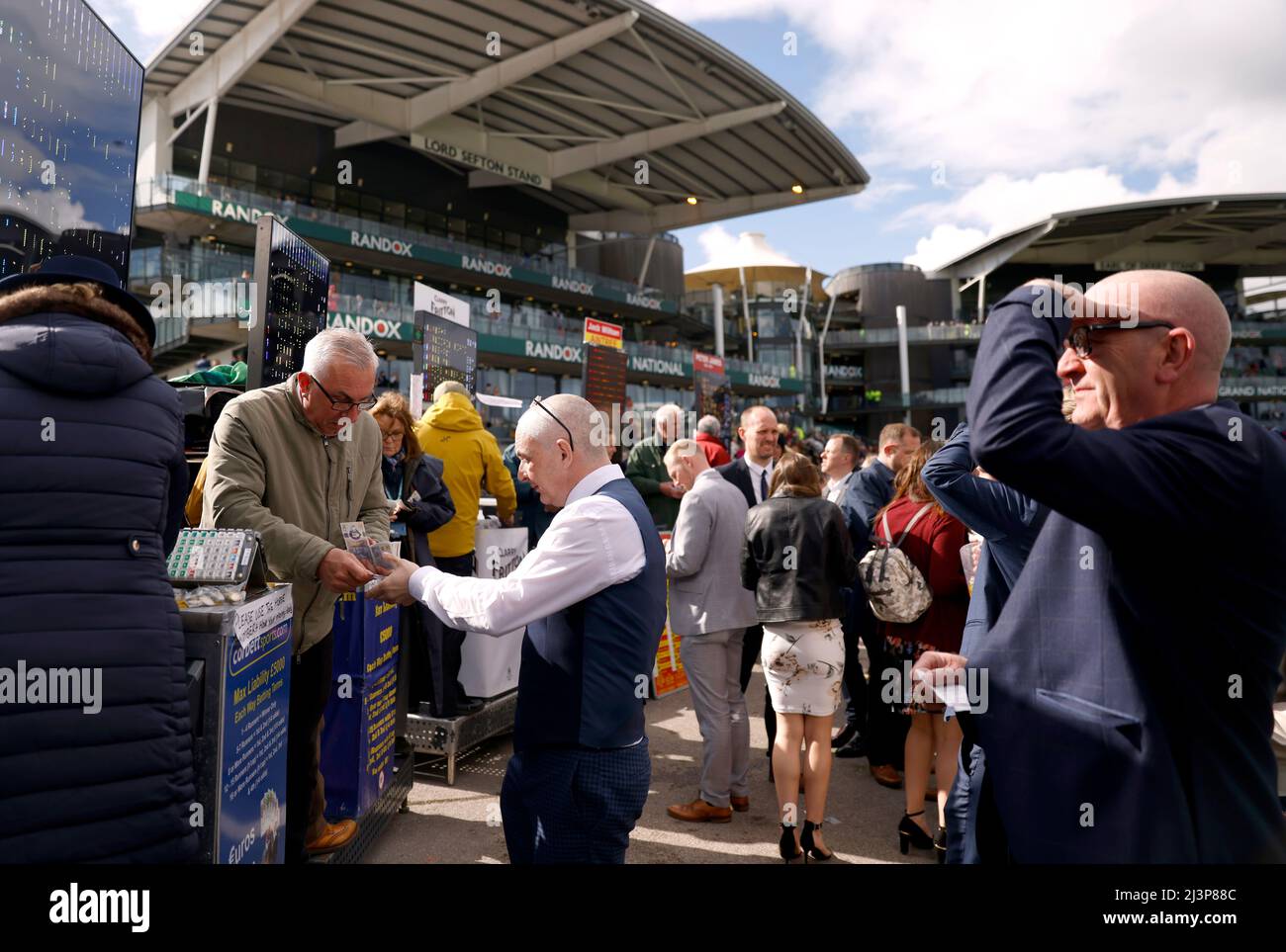Racegoers place bets at bookmaker stalls during Grand National Day of ...