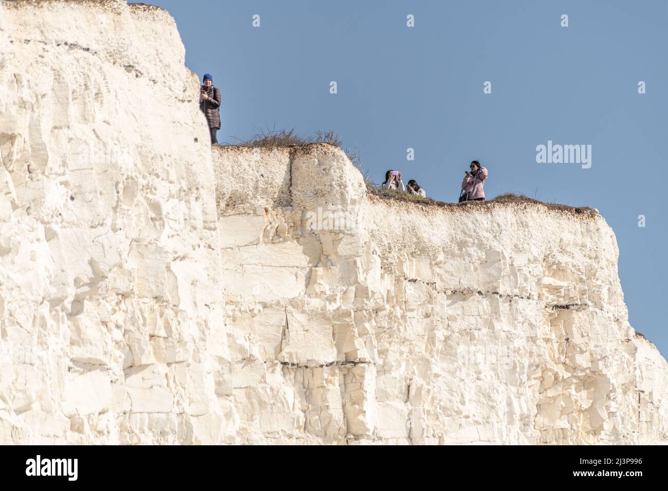Cliff edge danger, People stand precariously close to the cliff edge at ...