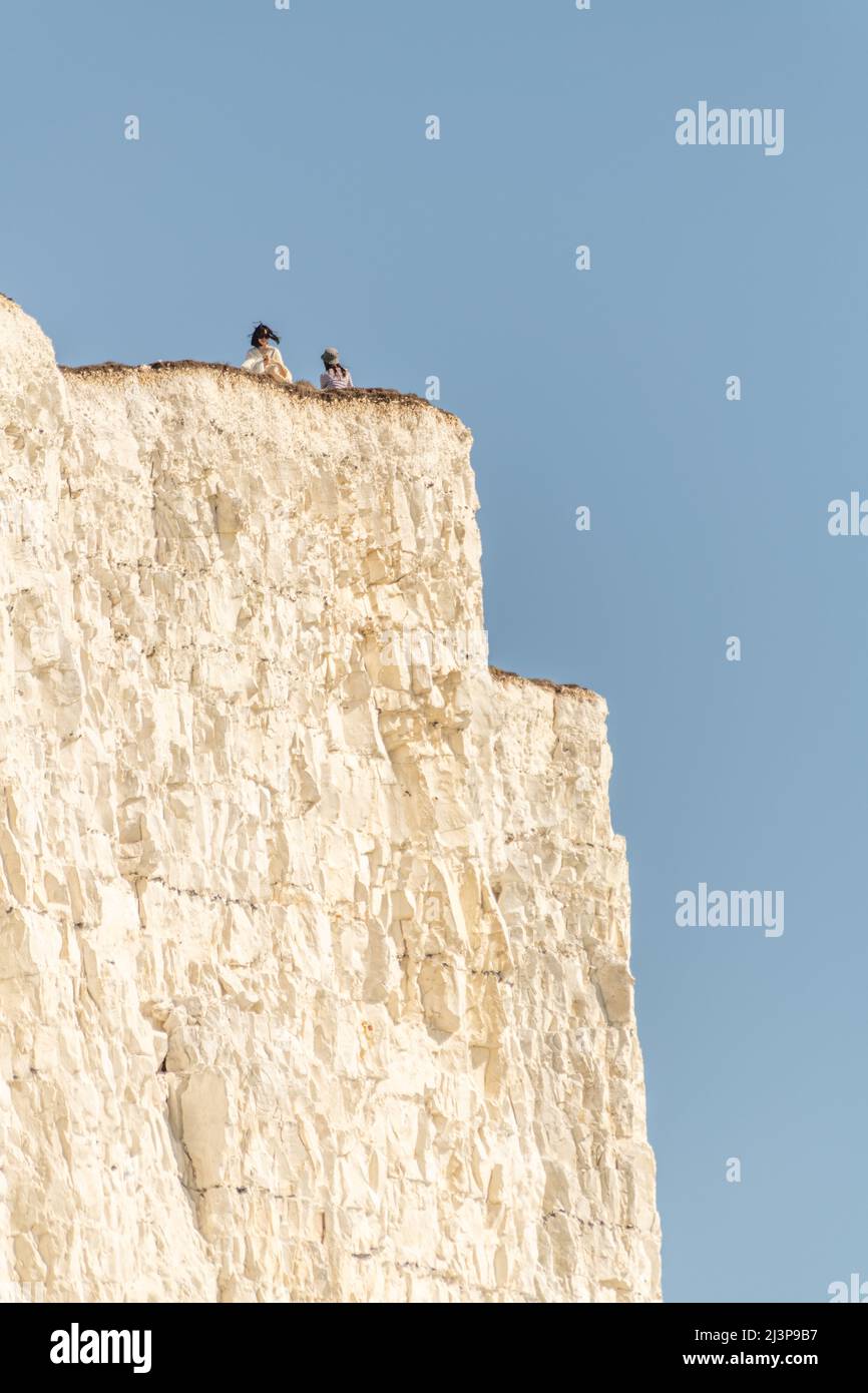 Cliff edge danger, People stand precariously close to the cliff edge at ...