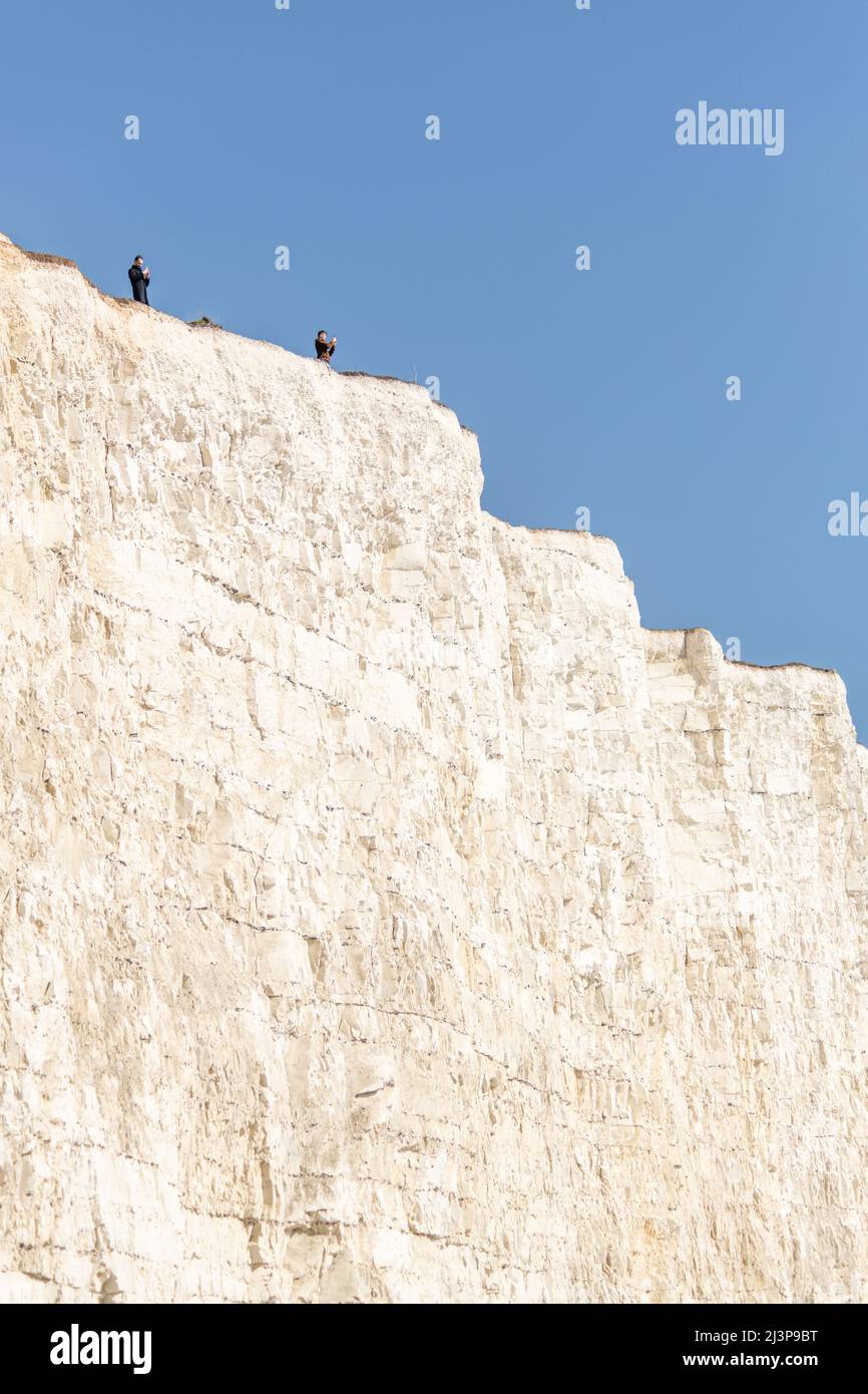 Cliff edge danger, People stand precariously close to the cliff edge at ...