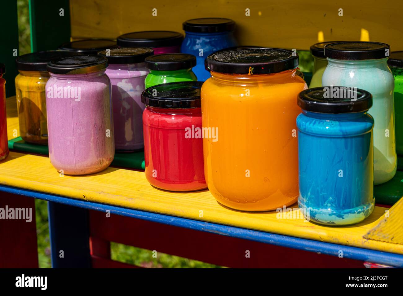 Bottles with acrylic paints of various colors. Blue, yellow, orange ...