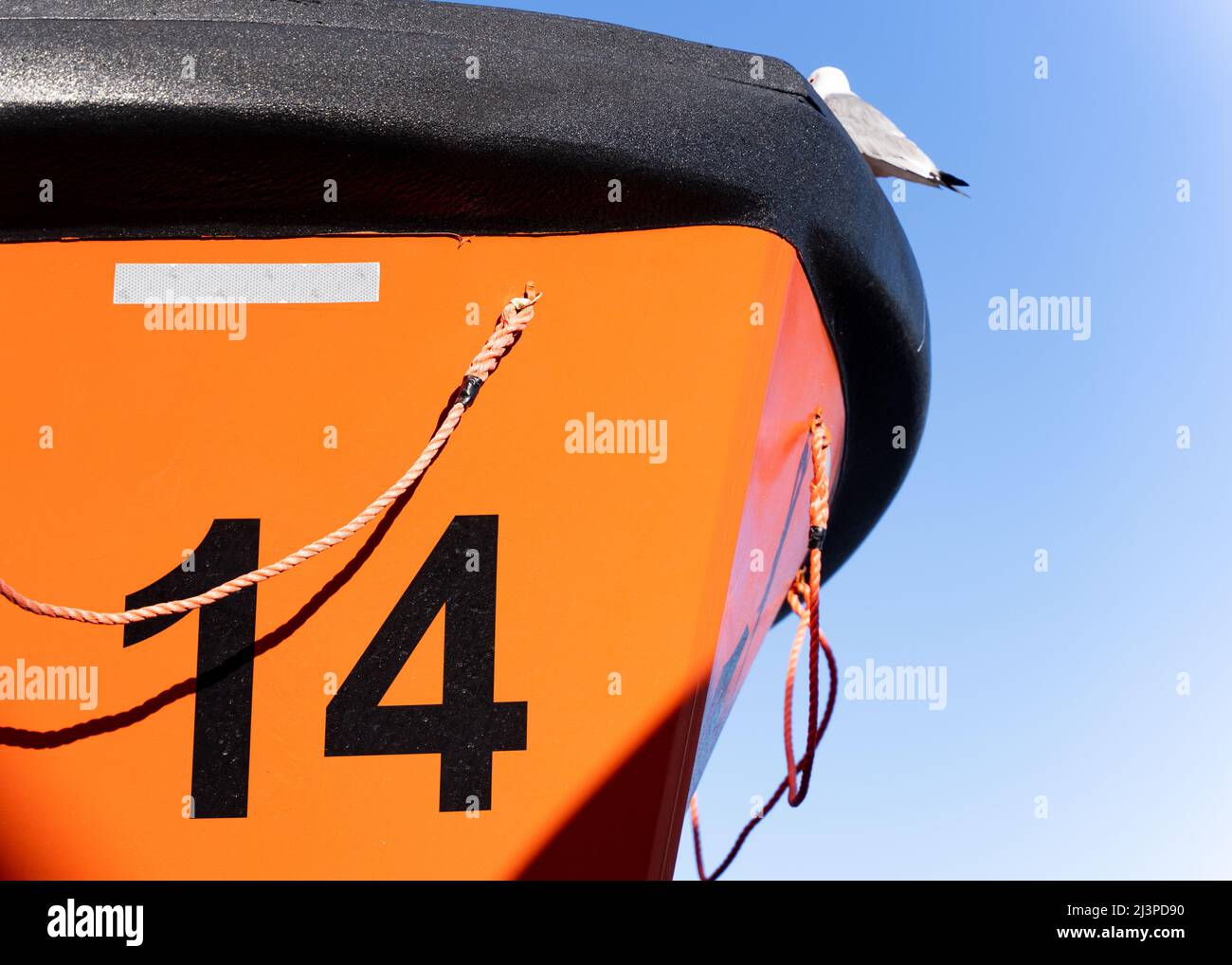 Orange lifeboat on side of north sea ferry boat crossing channel to ...