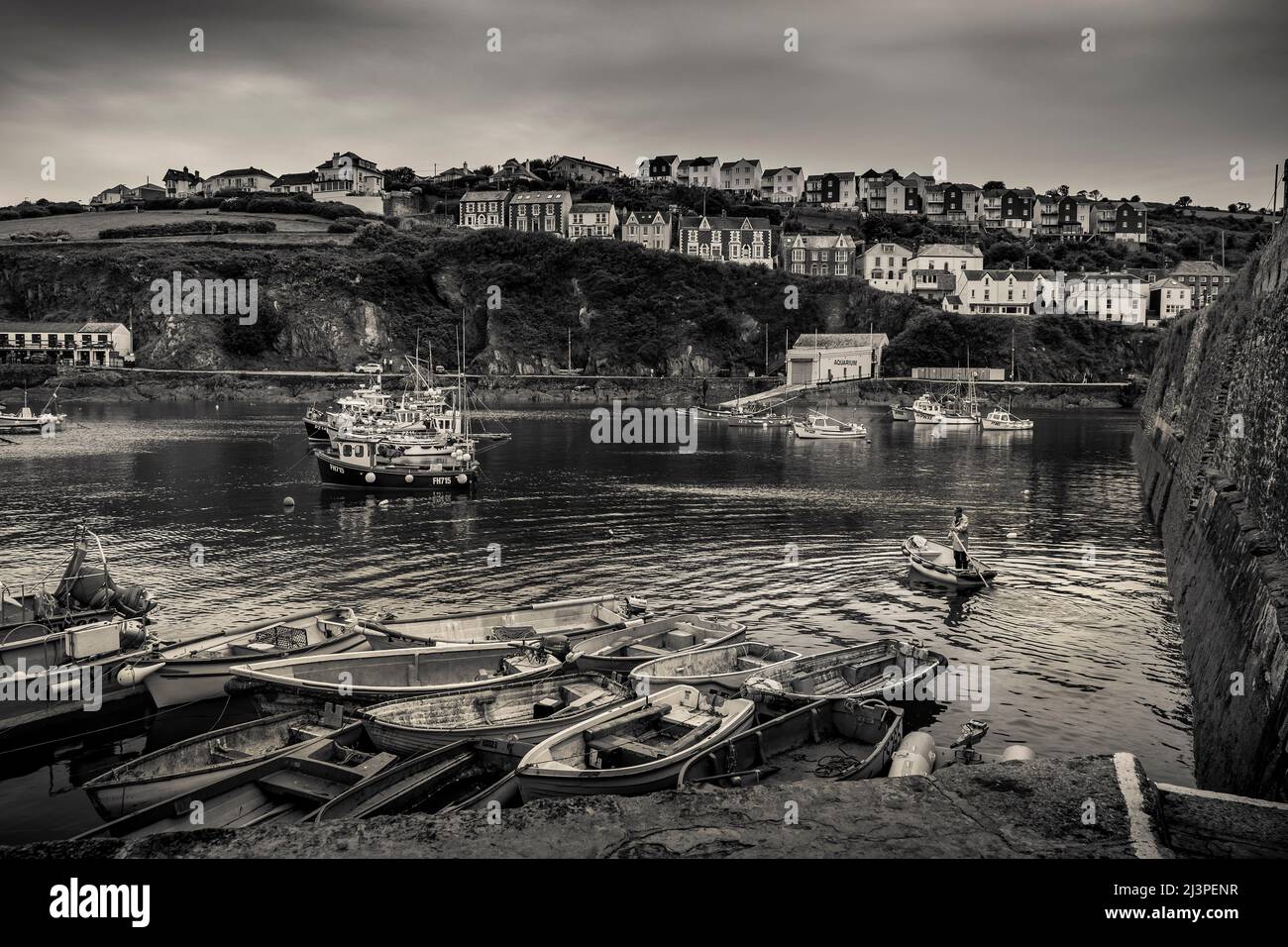 uk inshore fishing fleet, fisherman stern sculling to fishing boat ...