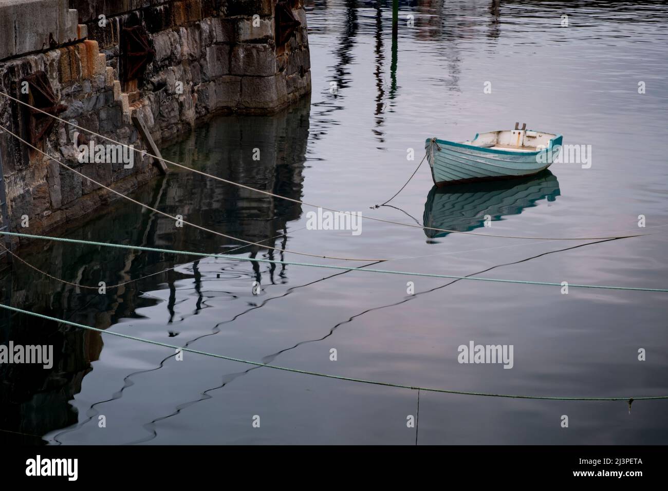 small clinker built dinghy with rope lines, moore in mevagissey harbour ...