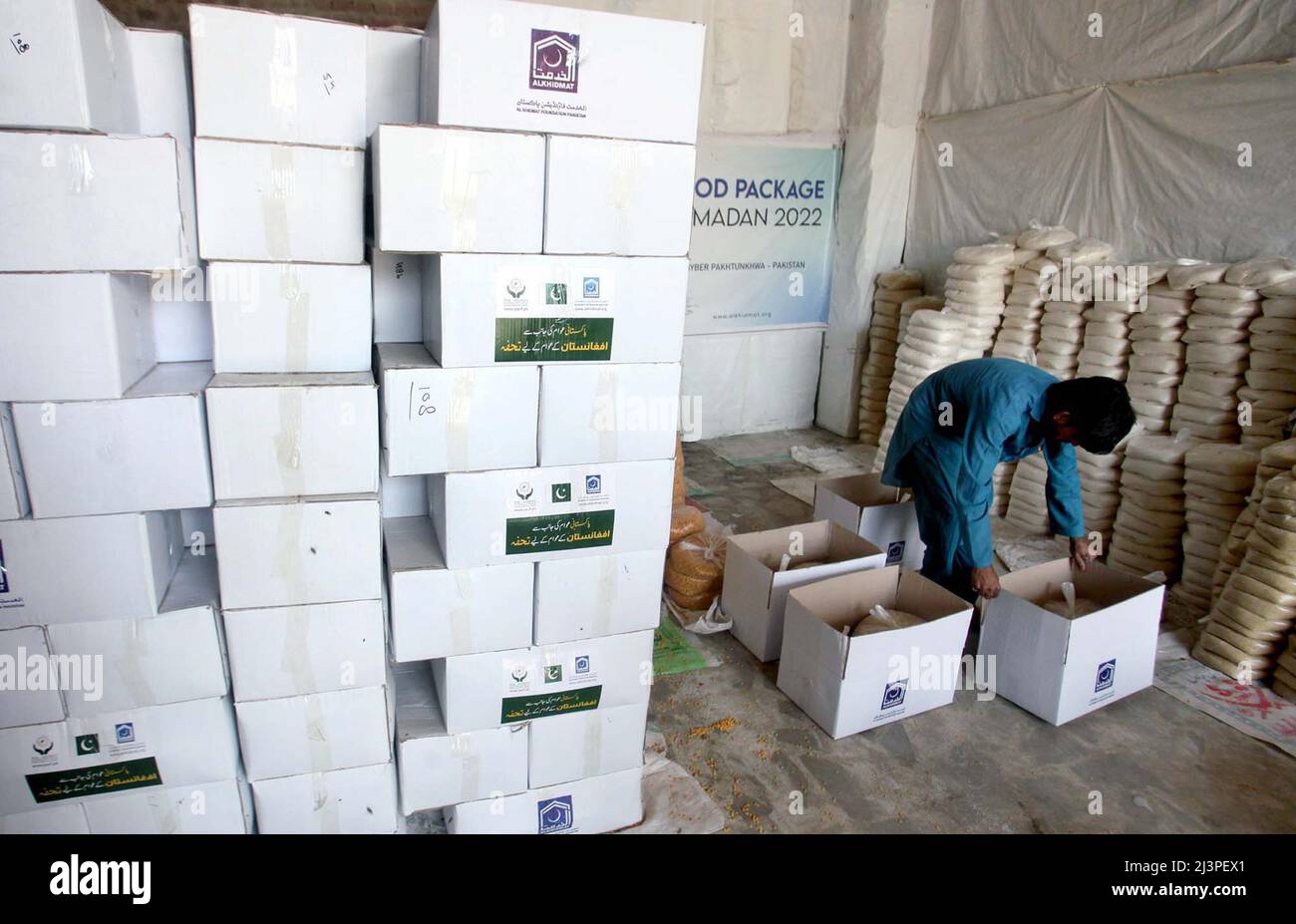 Volunteers busy in packing of relief goods during food aids for ...