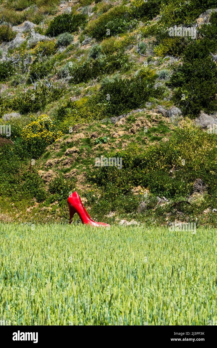 A red, larger than life, stiletto heel woman's shoe art installation in ...