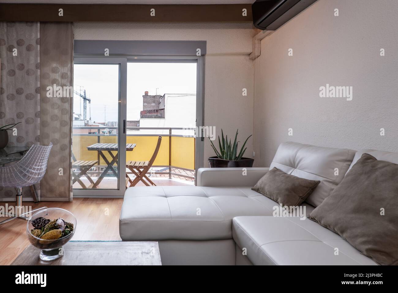 Living room with gray leather sofa, air conditioning unit and access to ...