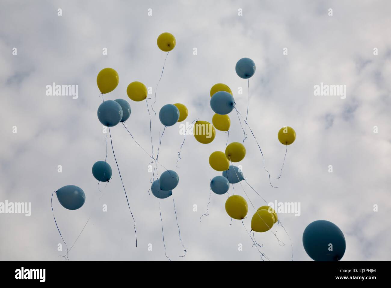 Yellow and Blue Balloons Flying to the Sky Stock Photo - Alamy