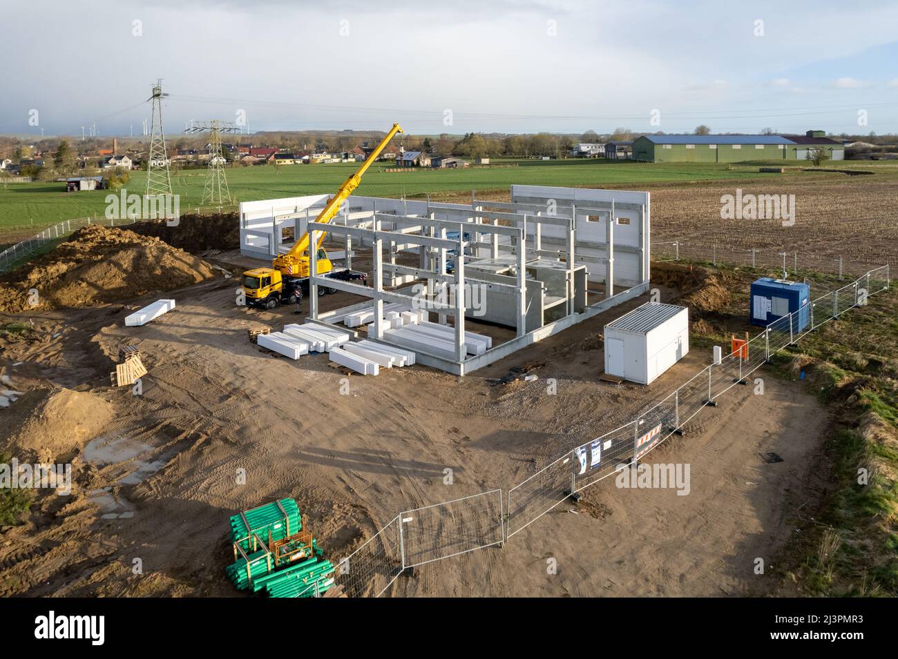 the basic structure of an industrial building is erected on a ...