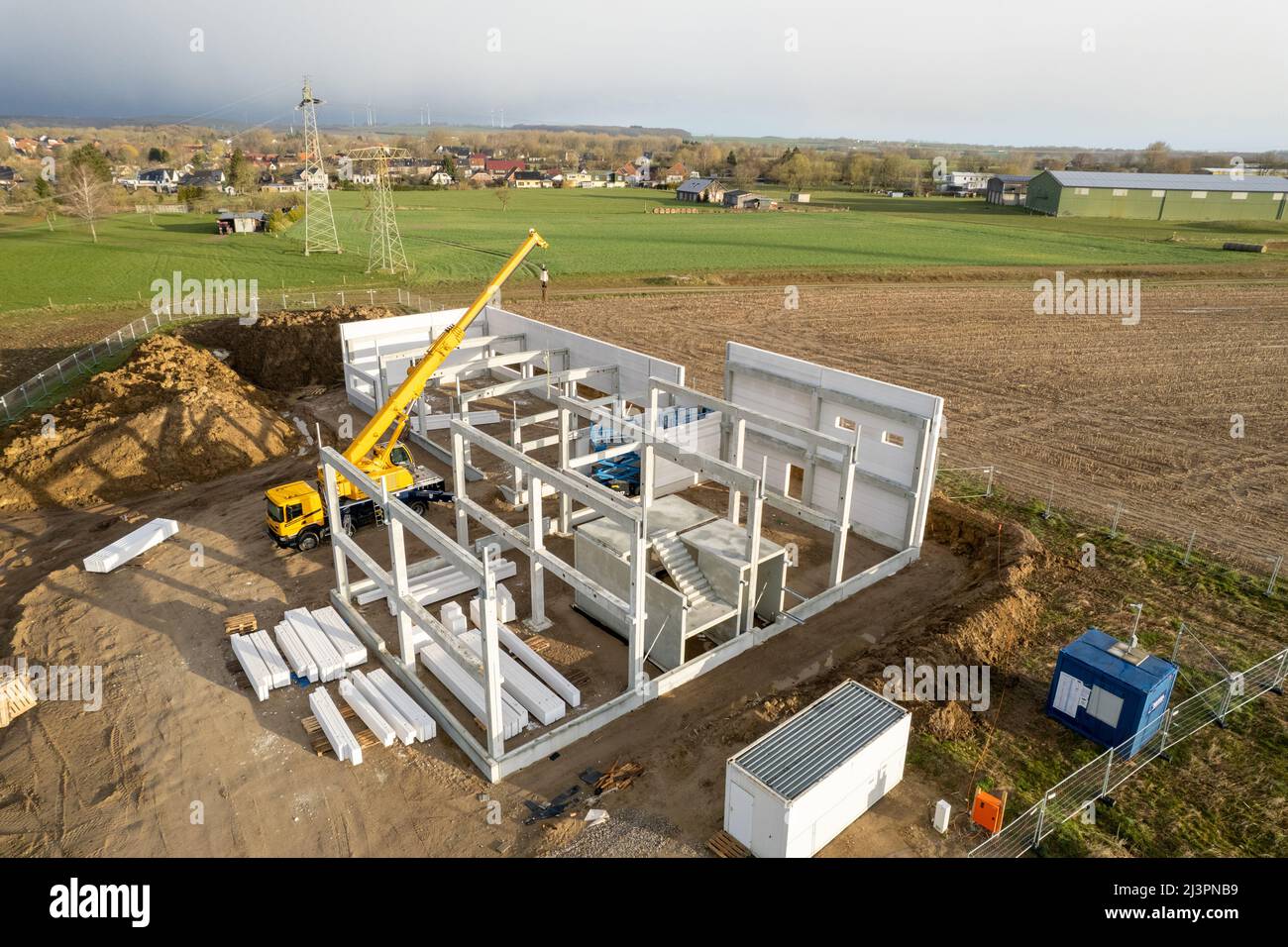 the basic structure of an industrial building is erected on a ...