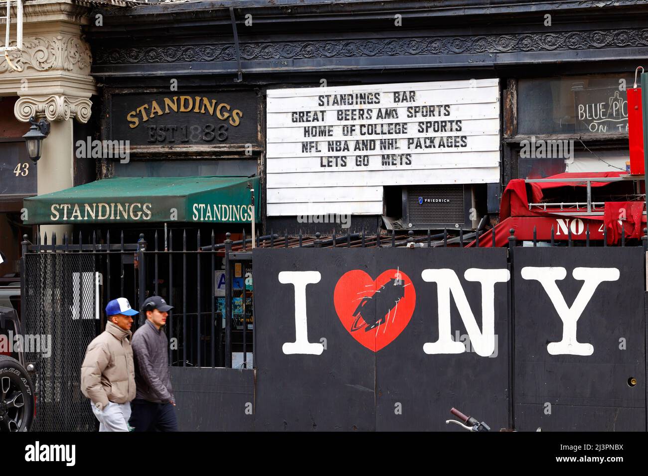 Two people walking past a bar hi-res stock photography and images - Alamy