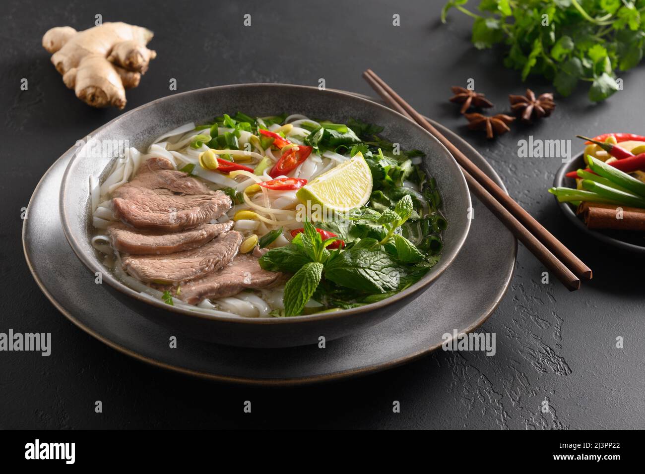 Pho Bo traditional Soup with beef, rice noodles, ginger, lime, chili ...