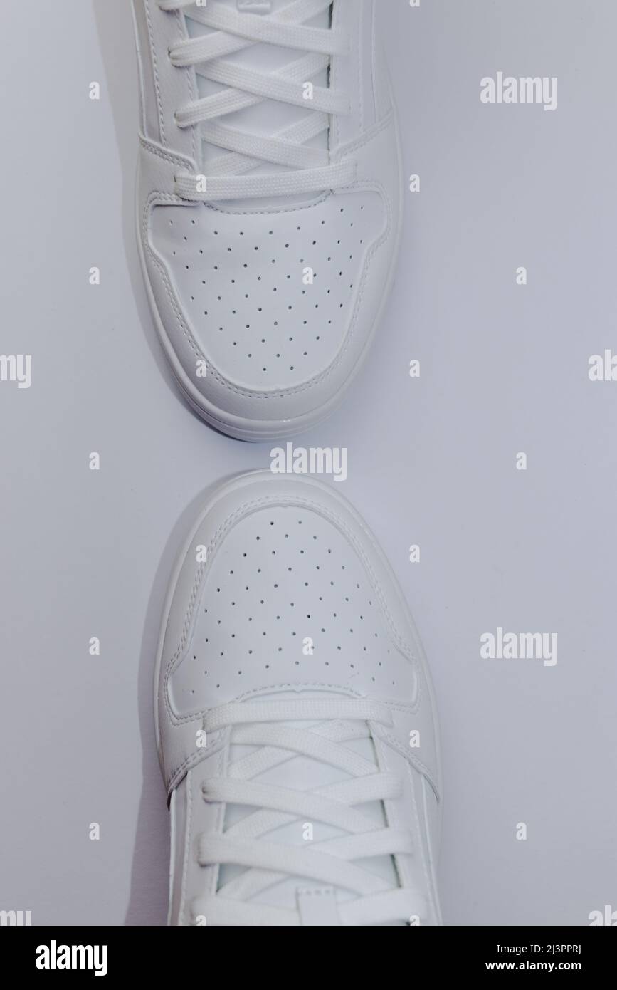 Top view of two white sneakers on a white background - vertical Stock ...