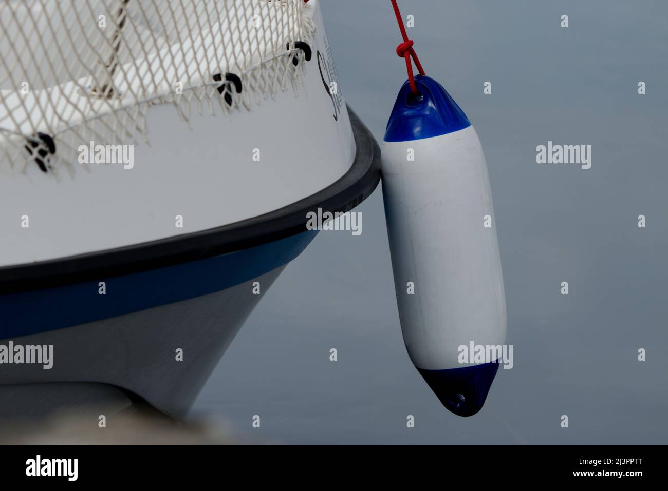Side of a white boat with boat buoy Stock Photo - Alamy