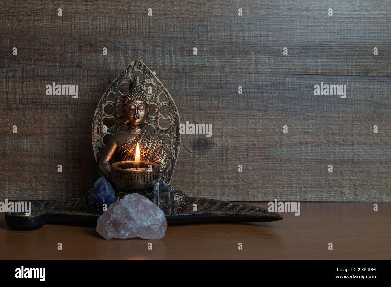 Buddha craft in meditation posture with candle Stock Photo - Alamy