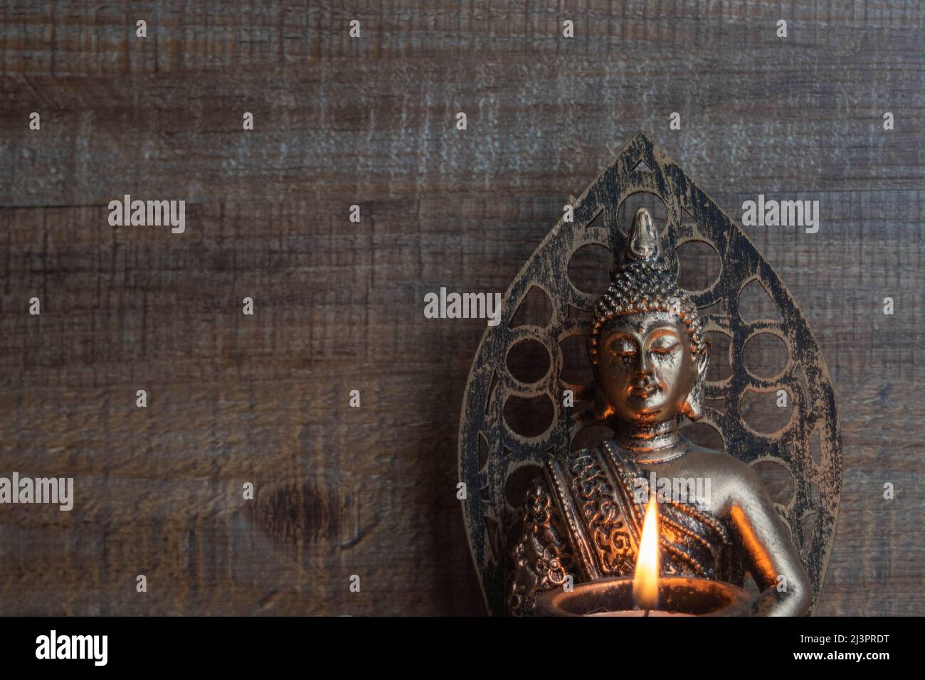 Buddha craft in meditation posture with candle Stock Photo - Alamy