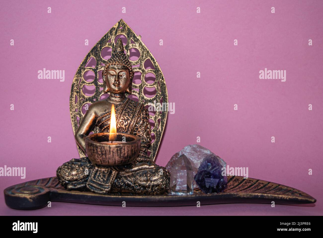 Buddha craft in meditation posture with candle Stock Photo - Alamy