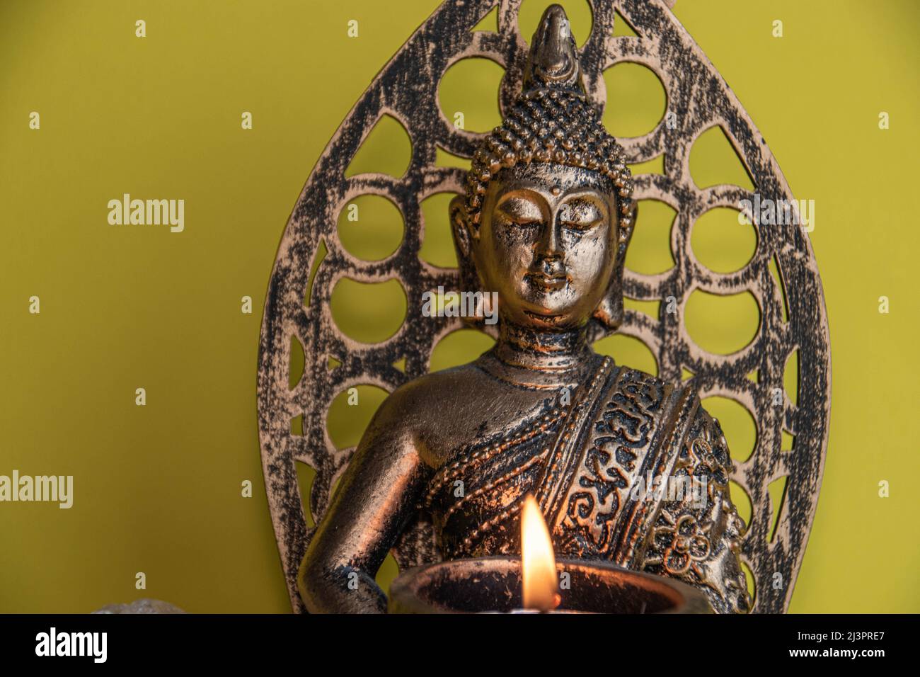 Buddha craft in meditation posture with candle Stock Photo - Alamy