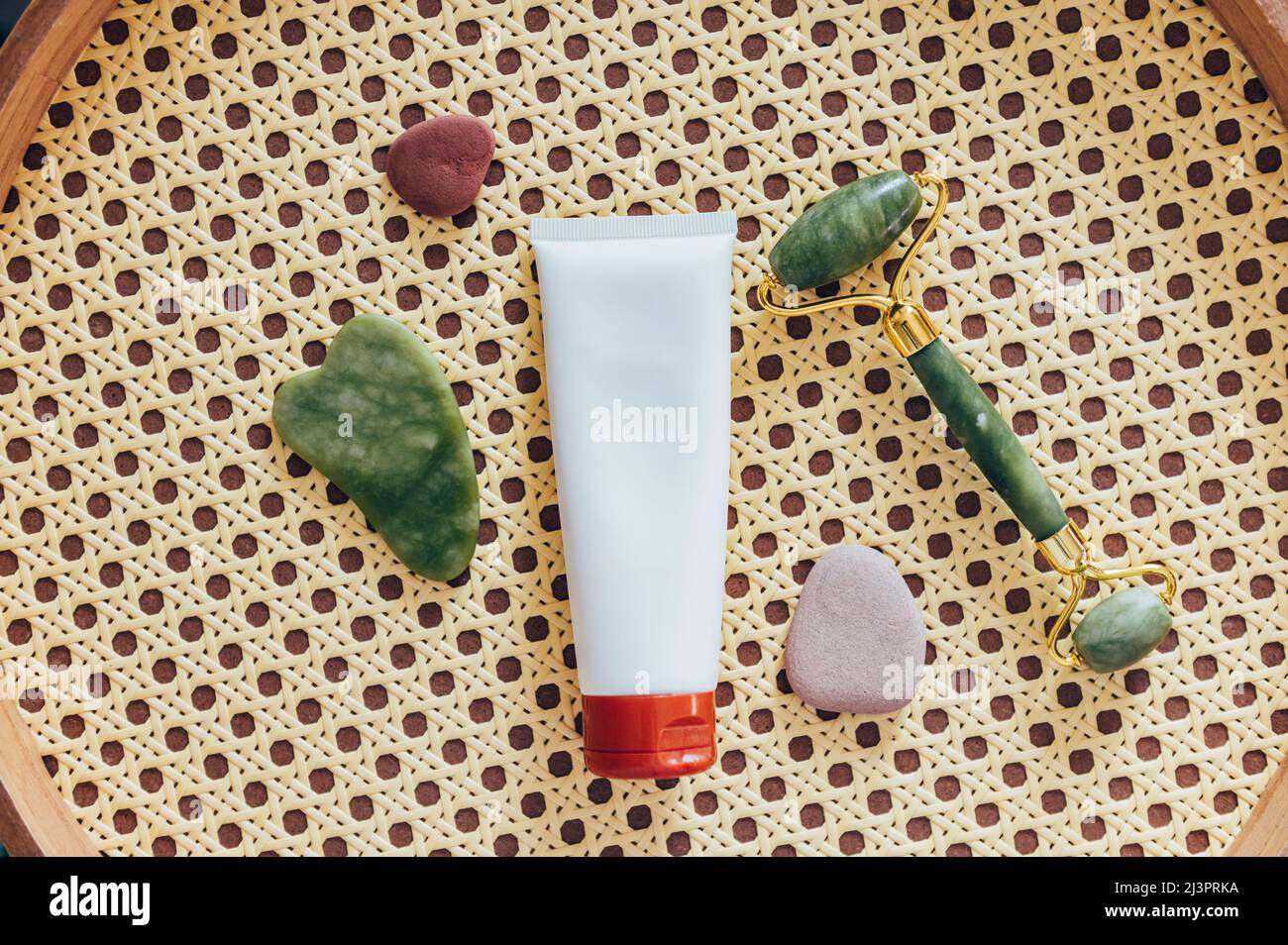 Jade face roller and Gua sha stone Stock Photo - Alamy