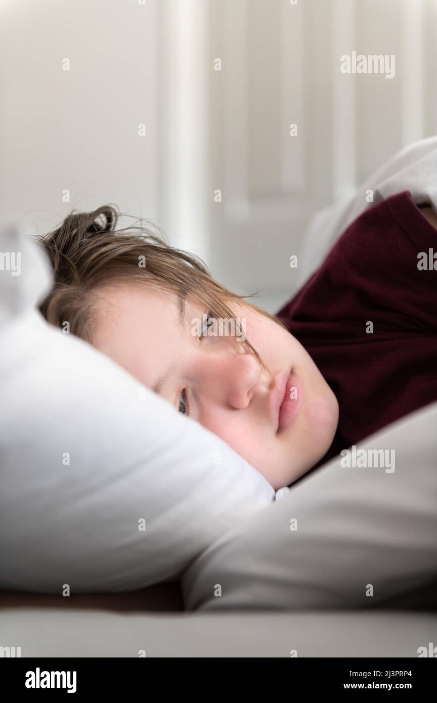 Sleepy teenager girl in bed Stock Photo - Alamy