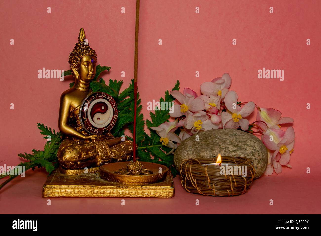 Buddha craft in meditation posture with candle Stock Photo - Alamy