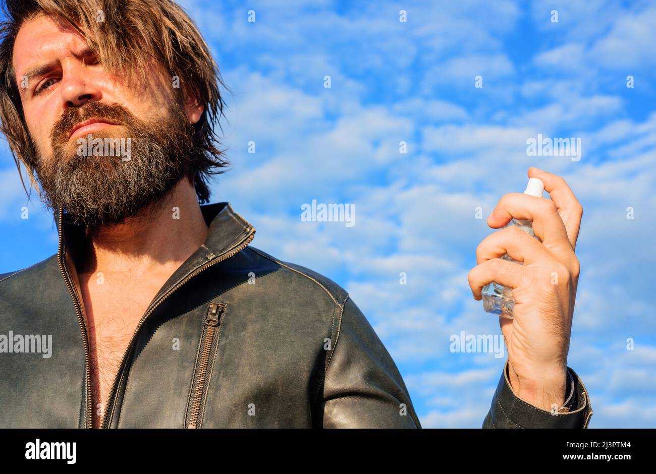 Male perfumes, cologne, fragrance, cosmetics. Bearded man in leather ...