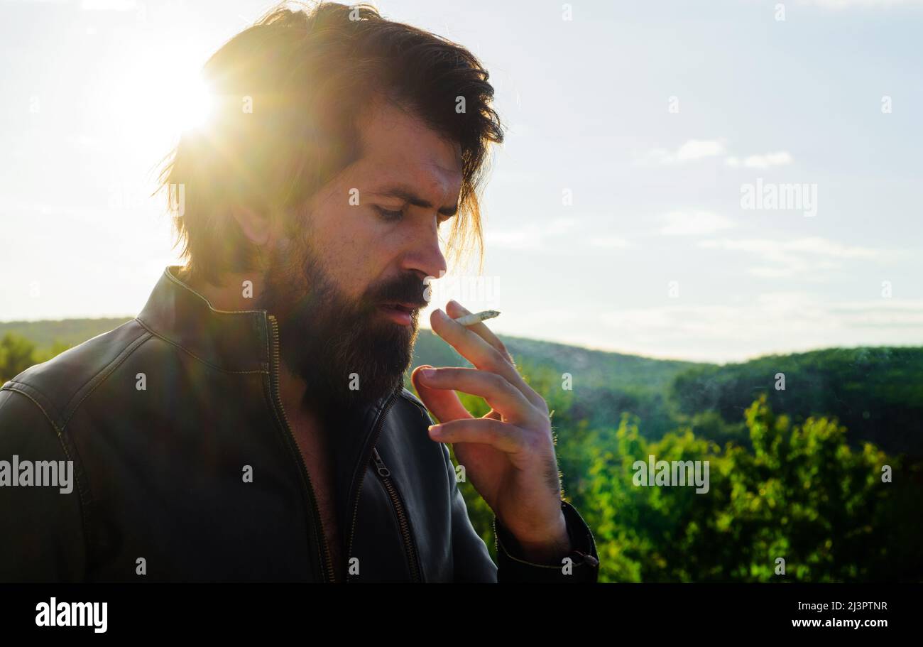 Handsome man smoking cigarette hi-res stock photography and images - Alamy