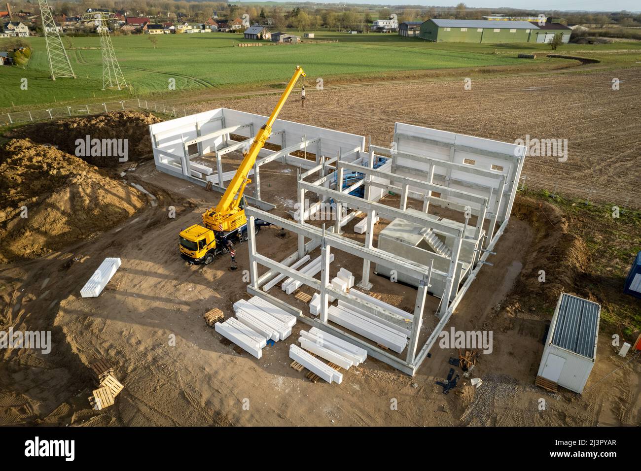 the basic structure of an industrial building is erected on a ...