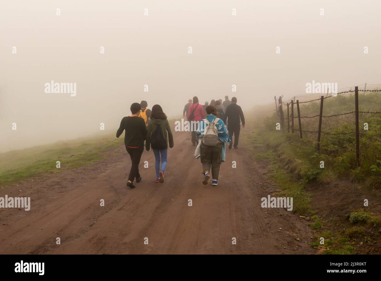 Back view of refugees walk to the border in a cold day under fog Stock ...