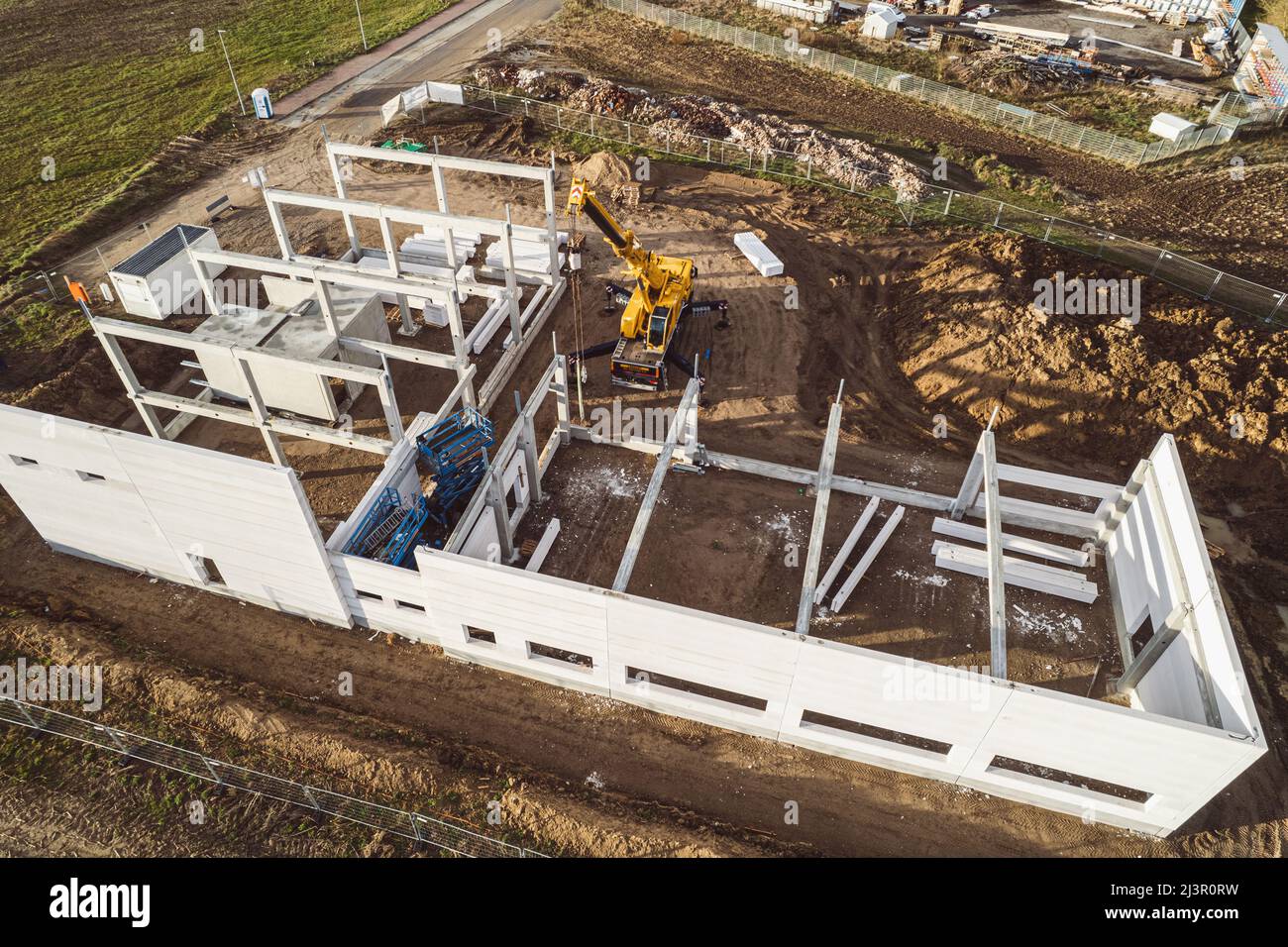 the basic structure of an industrial building is erected on a ...