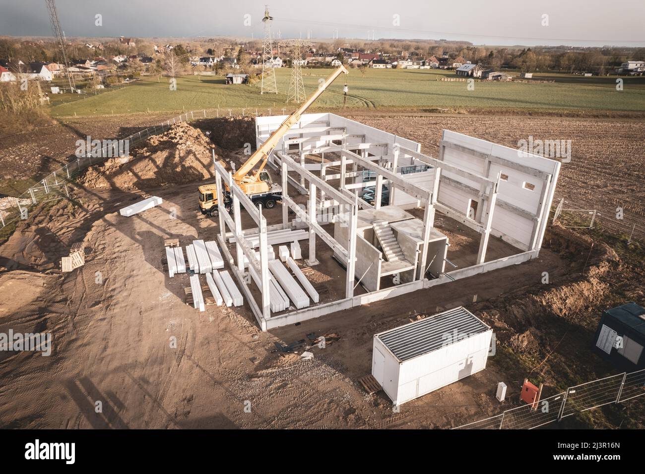 the basic structure of an industrial building is erected on a ...