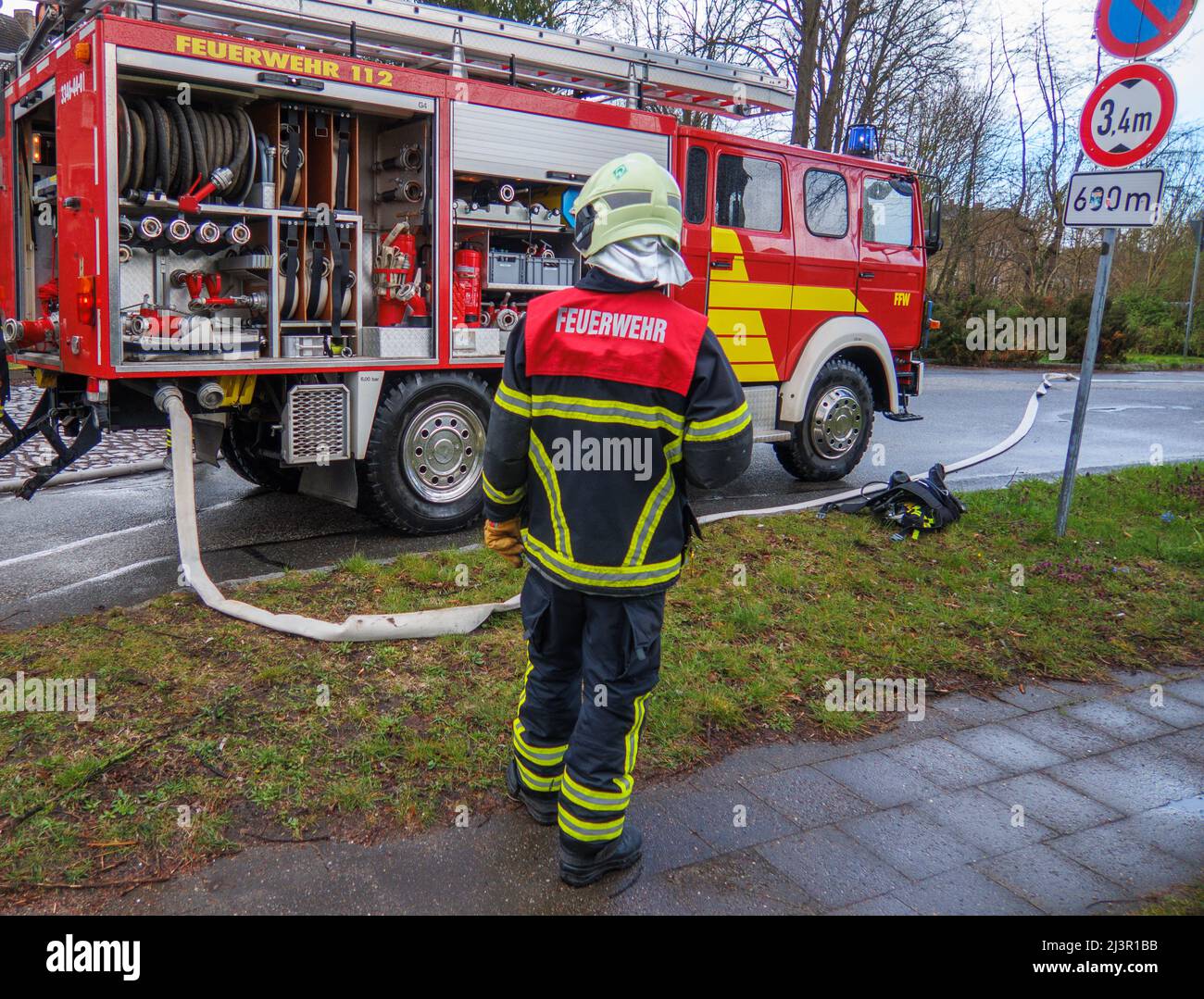 a firefighter stands in front of his fire truck Stock Photo - Alamy