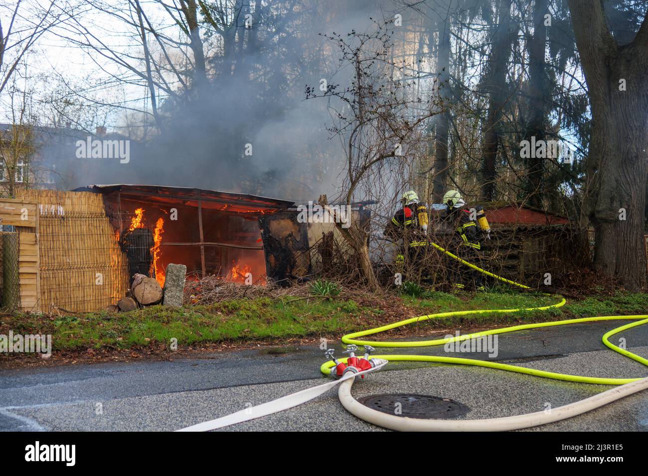 House fire with a garden hose hi-res stock photography and images - Alamy