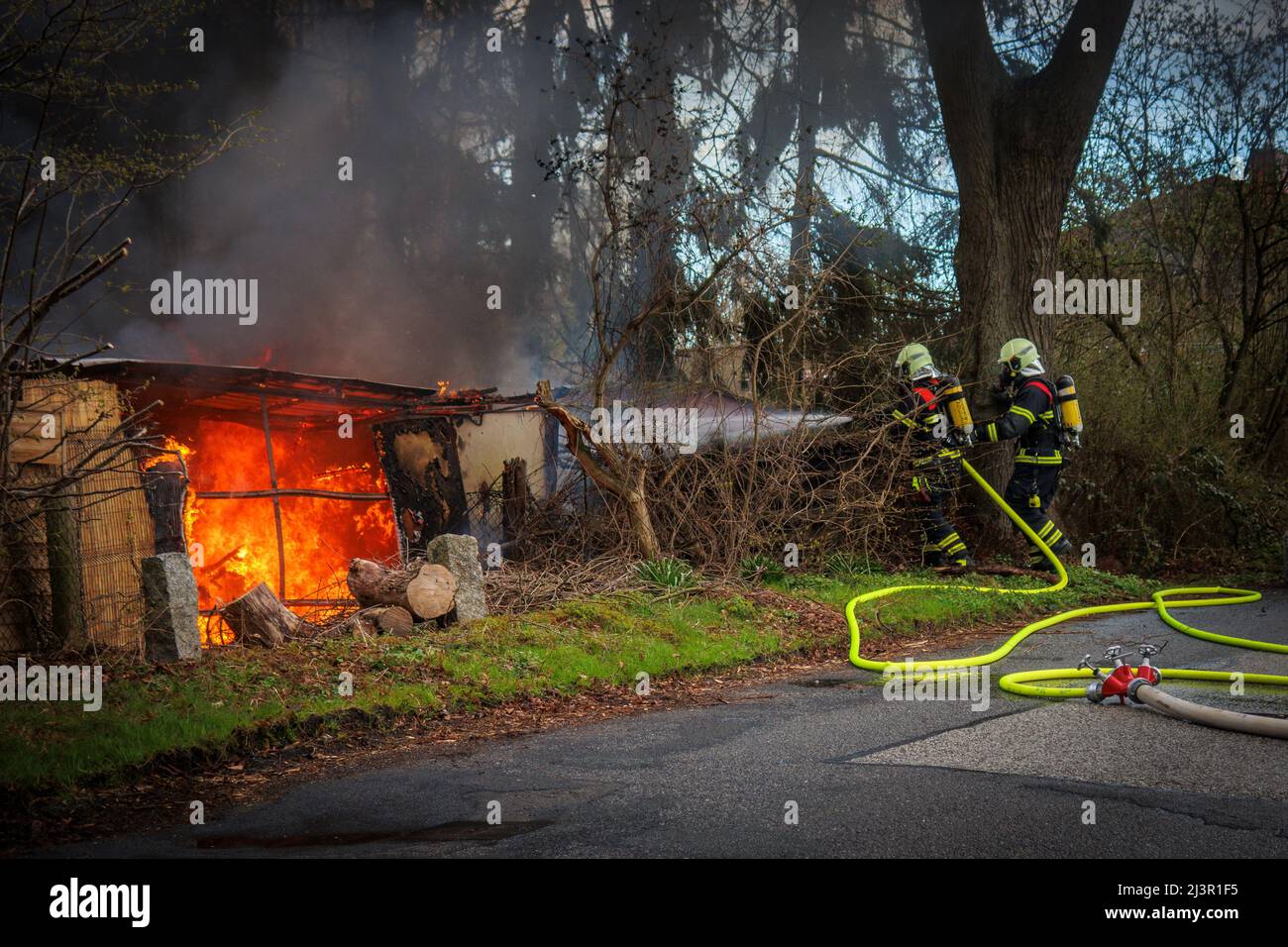 House fire with a garden hose hi-res stock photography and images - Alamy