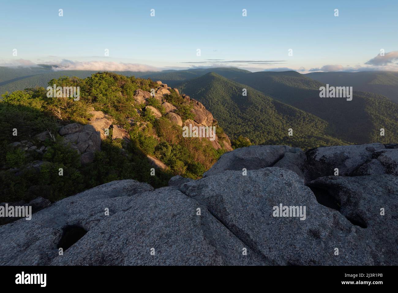 Morning light illuminating the rocky summit of Old Rag Mountain during ...