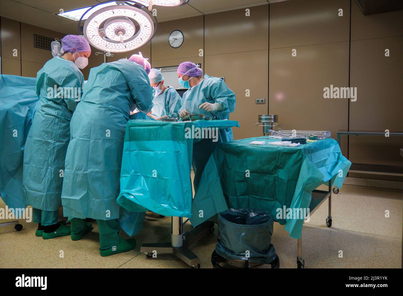 an operation is performed in an operating room in a Hospital Stock ...