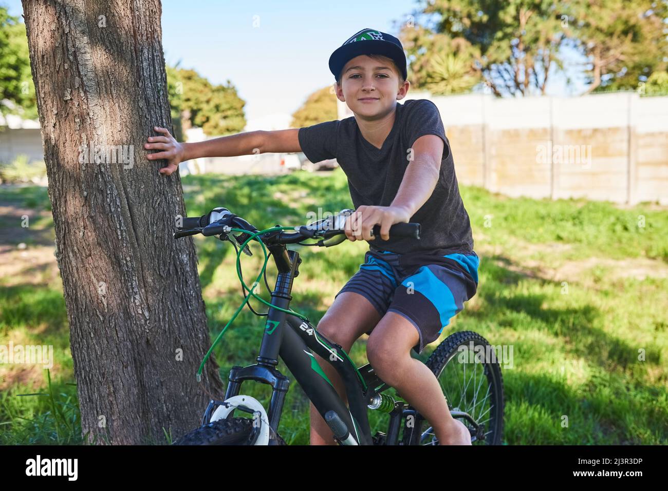 Wanna ride. Cropped portrait of a young boy riding his bike outside Stock Photo - Alamy