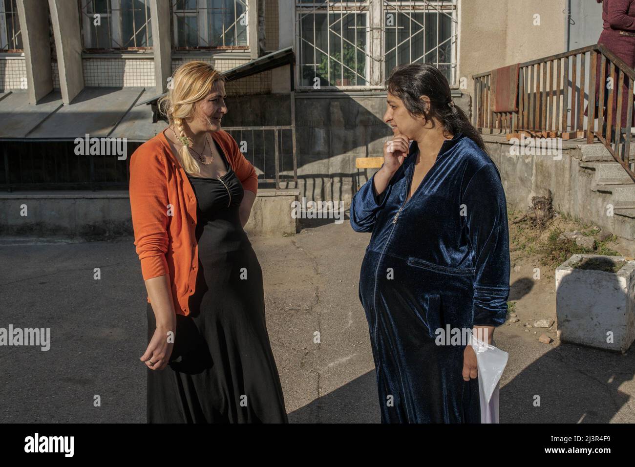 Two women from the "romanie" community who are refugees talk, one of ...