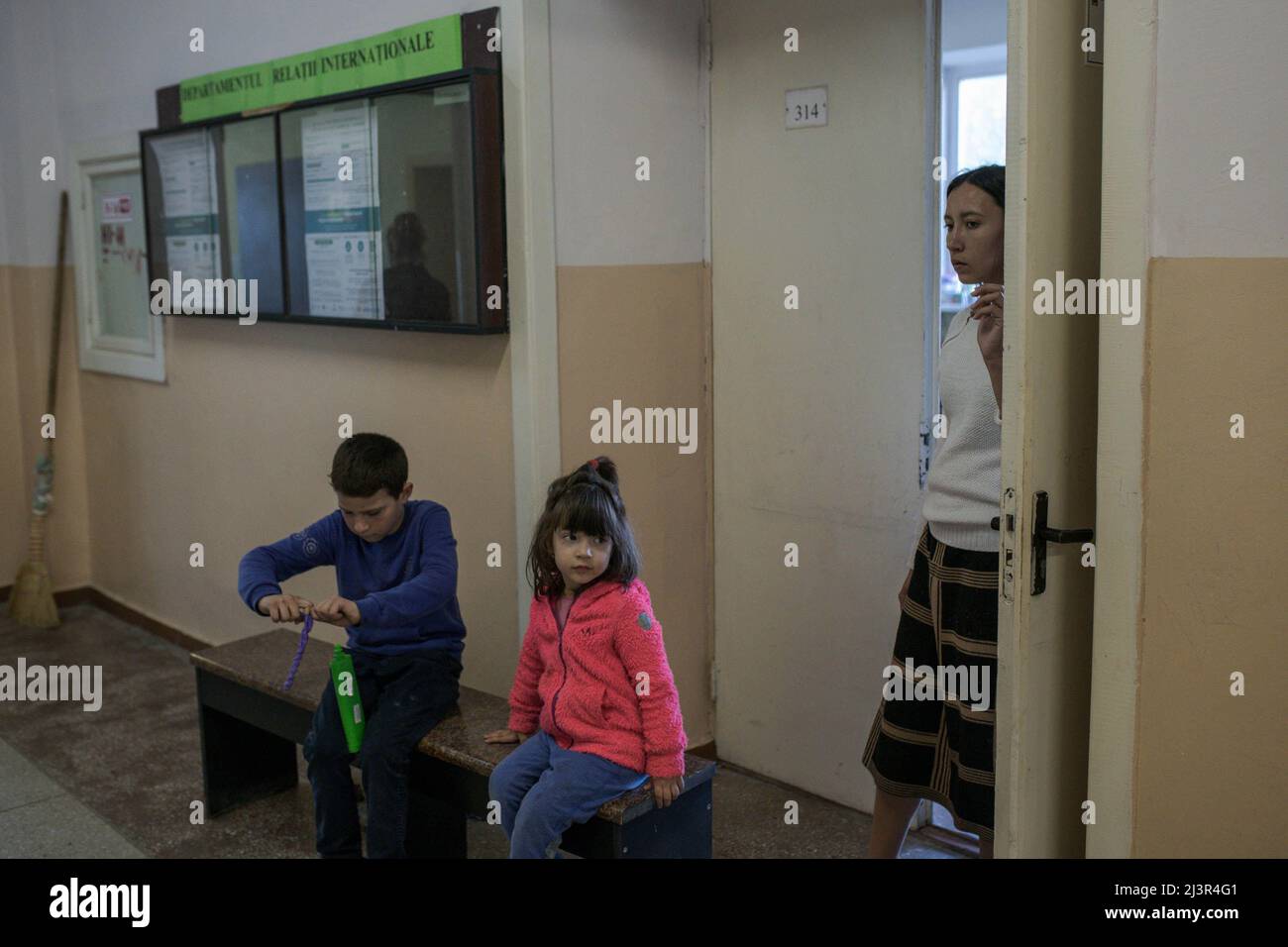 A Roma woman and two children seen at the corridors of the refugee ...