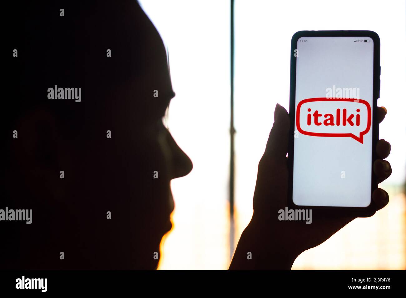 In this photo illustration, a woman's silhouette holds a smartphone ...