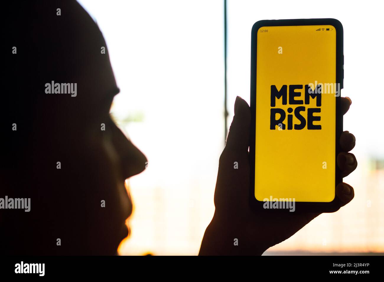 In this photo illustration, a woman's silhouette holds a smartphone ...