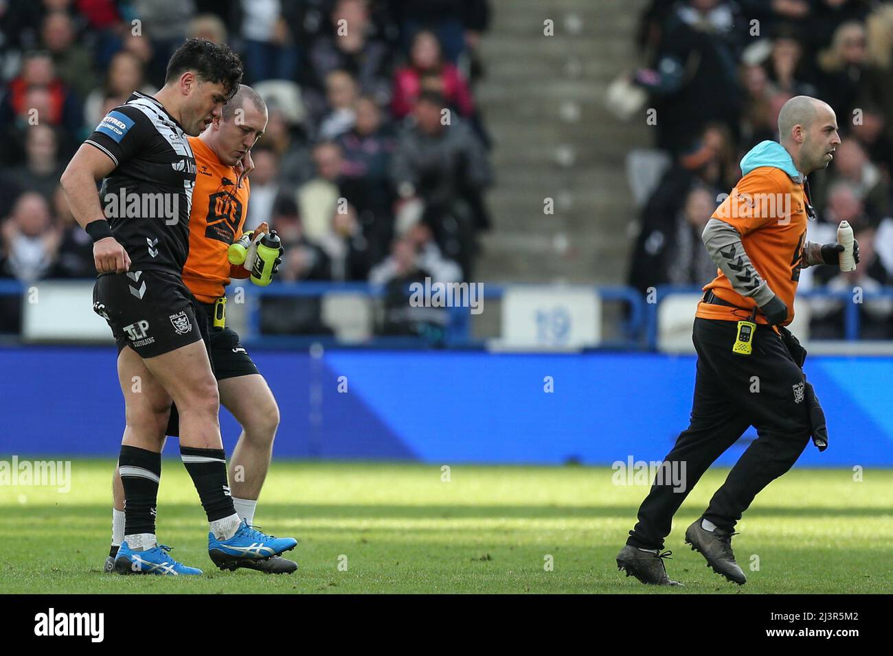 Andre Savelio #11 of Hull FC is helped off the pitch after receiving an ...