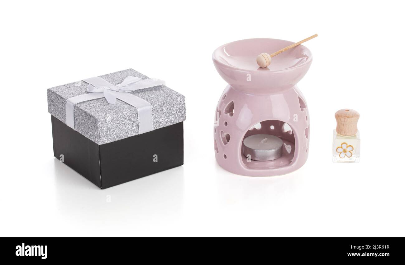 Pink perfume burner with a candle on a white background Stock Photo - Alamy